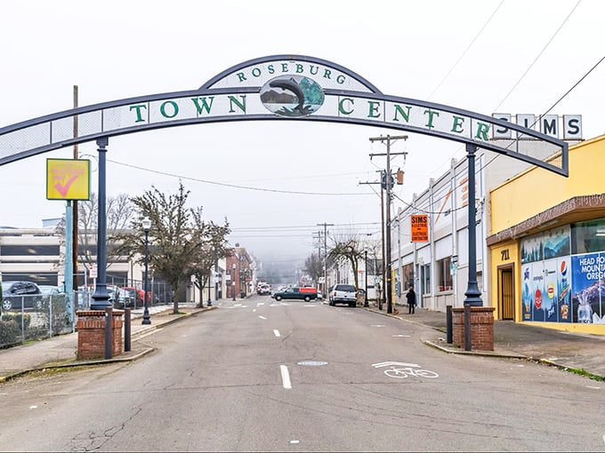 "Welcome to Roseburg!" The iconic arch stands like a budget-friendly rainbow leading to affordable small-town treasures.