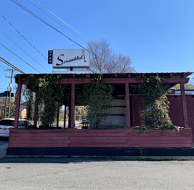 Scrambled's rustic entrance, draped with greenery, promises a breakfast experience as fresh as the morning dew.