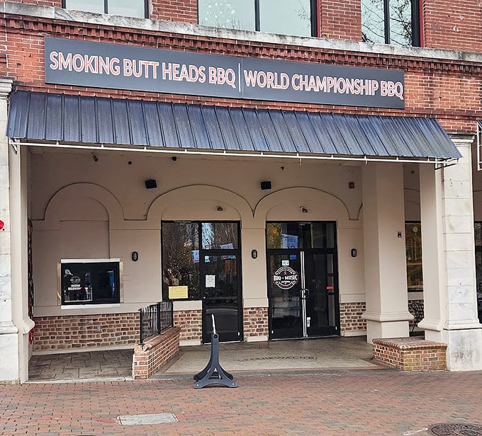 Bold signage and brick charm announce a BBQ joint where championship-level flavors meet playful personality on Main Street.