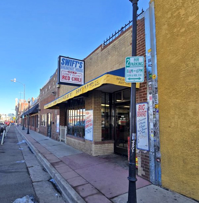 Swift's Breakfast House announces itself with no-nonsense clarity on Santa Fe Drive. That yellow awning is like a beacon for breakfast lovers.