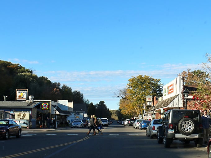 Taylors Falls' main street captures that perfect small-town moment where neighbors cross paths and autumn colors frame everyday life beautifully.