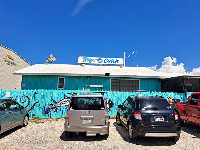 The Big Catch's vibrant turquoise exterior promises tropical flavors and fresh Gulf Coast grouper inside.