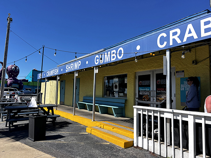 The Shrimp Basket blue awning proudly announces "SHRIMP &bull; GUMBO &bull; CRABCLAWS" like a delicious roadside billboard. Gulf Shores' seafood simplicity at its finest!