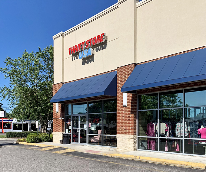 Thrift Store USA's patriotic red, white, and blue branding stands tall against Norfolk's blue sky. Bargain hunting with American pride!