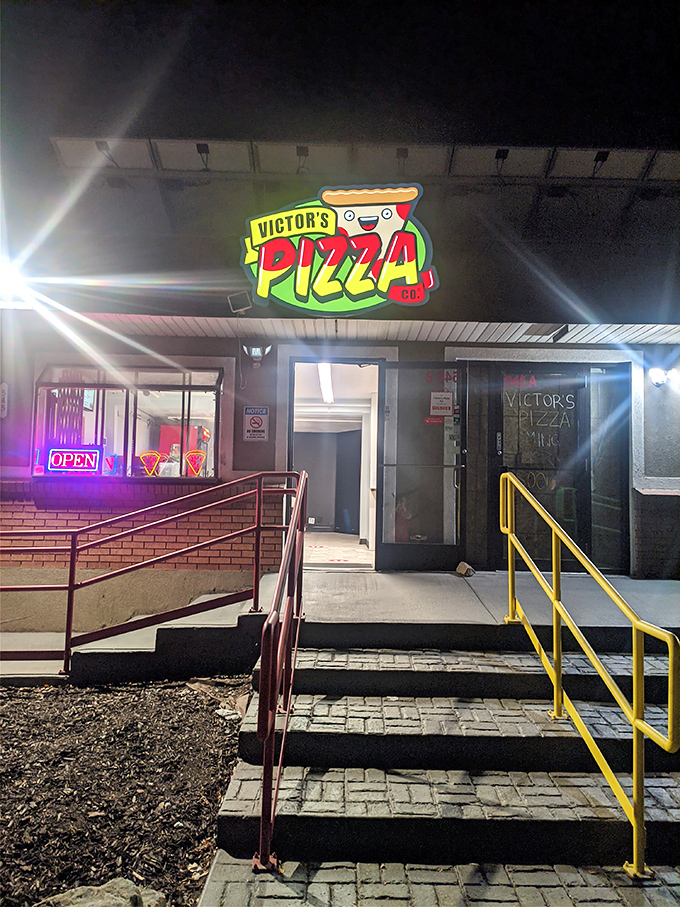 Victor's cheerful cartoon logo greets hungry visitors like an old friend. That smiling pizza slice knows exactly what joy awaits you!