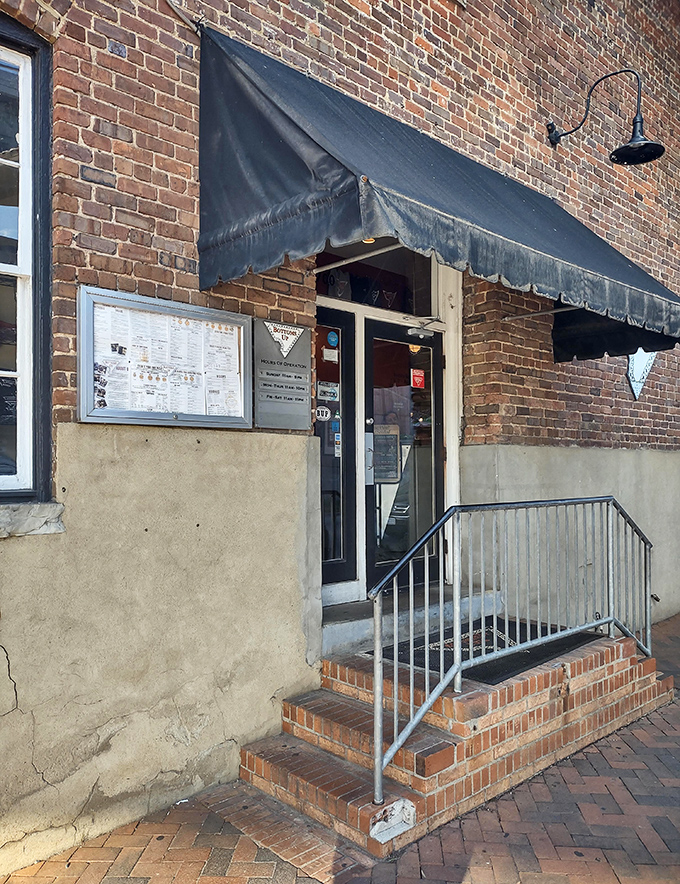 That weathered brick and vintage signage tell stories of countless pizza nights and satisfied customers through the decades.