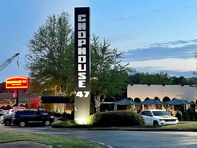 The illuminated Chophouse '47 sign stands tall against the evening sky, a beacon for serious steak enthusiasts.