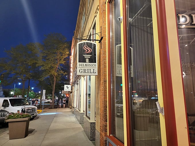 Those elegant windows and classic architecture hint at the timeless dining experience waiting inside Delmonico Grill.
