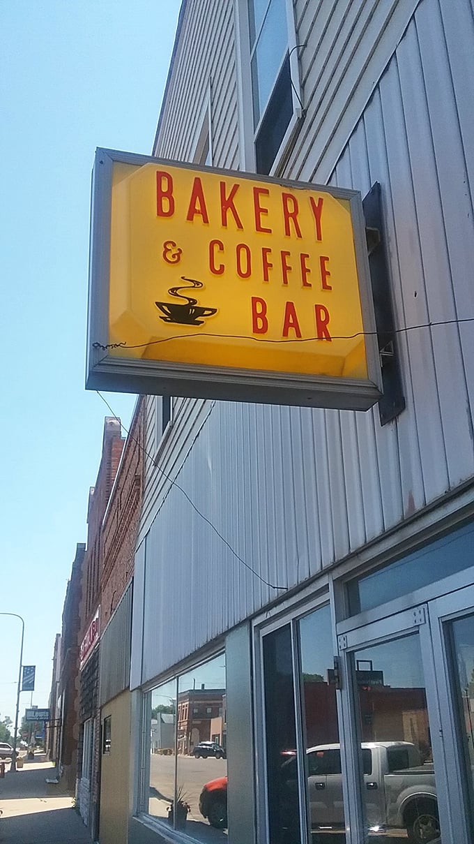 That "Bakery & Coffee Bar" sign glows like a beacon of hope for caffeine-deprived travelers on South Dakota mornings.