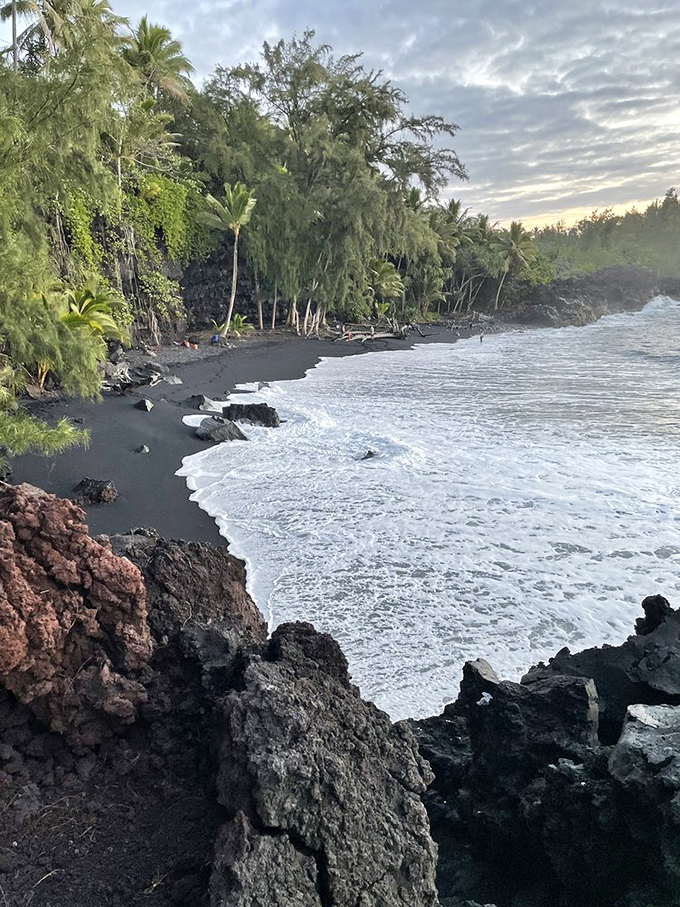 Lush vegetation frames Kehena's volcanic shoreline where new land meets ancient ocean. The Big Island's youth movement&mdash;this beach is younger than your favorite classic rock albums!