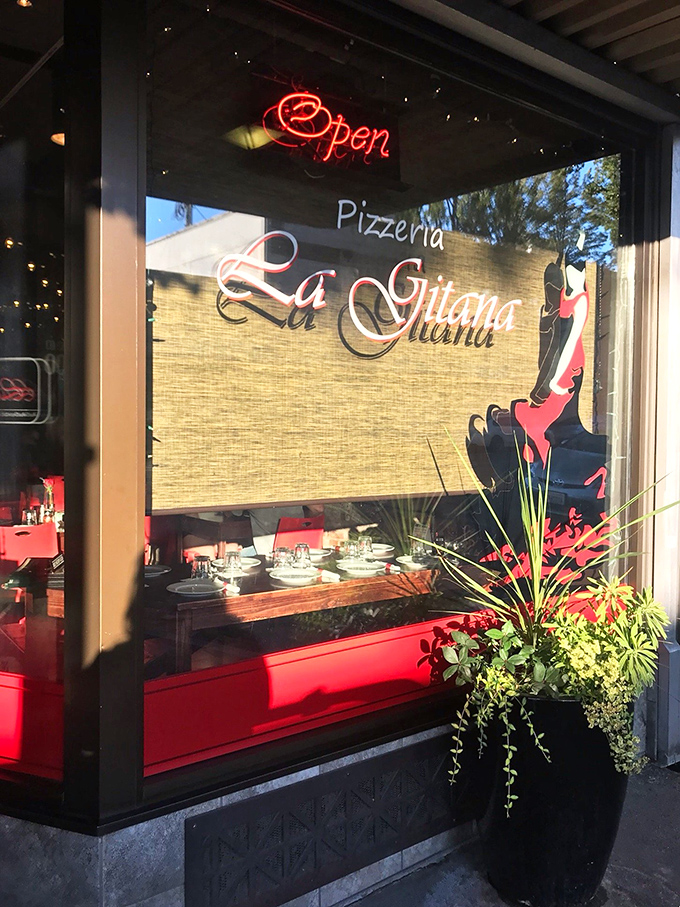 The elegant script of "La Gitana" promises pizza with personality. That red interior sets the stage for memorable meals.