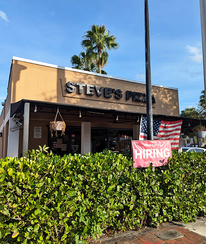 The American flag and simple storefront at Steve's hide a pizza paradise that locals have treasured for decades.