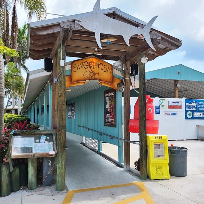 The turquoise building with its distinctive swordfish sign captures Old Florida charm. Walking under that silver fish feels like passing through a portal to seafood paradise.