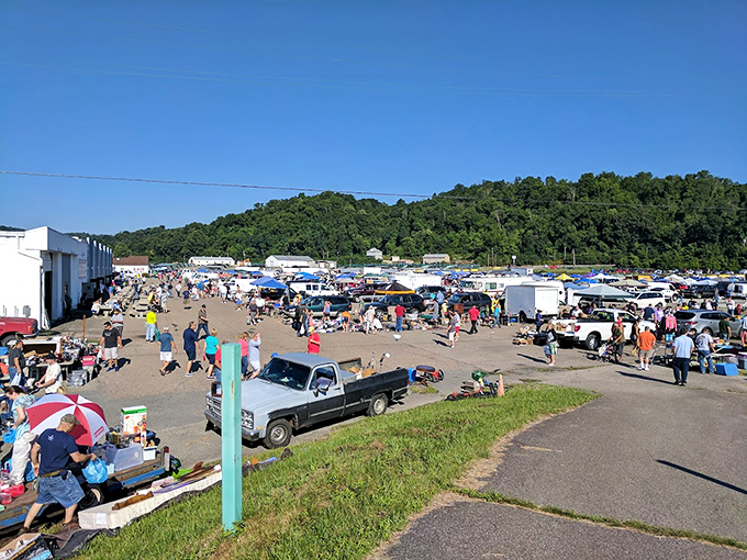 Mountains frame this sprawling flea market where treasure hunters gather under summer skies seeking deals galore.