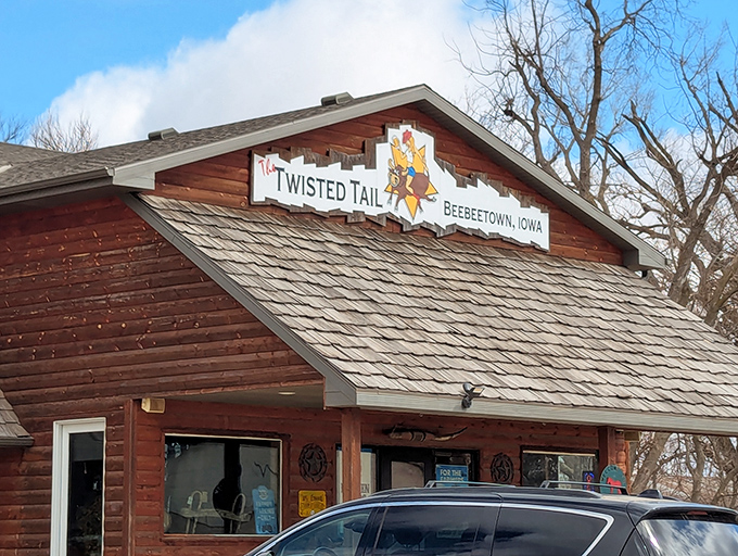 The rustic cabin exterior with that playful sign promises good times, cold drinks, and steaks worth writing home about.