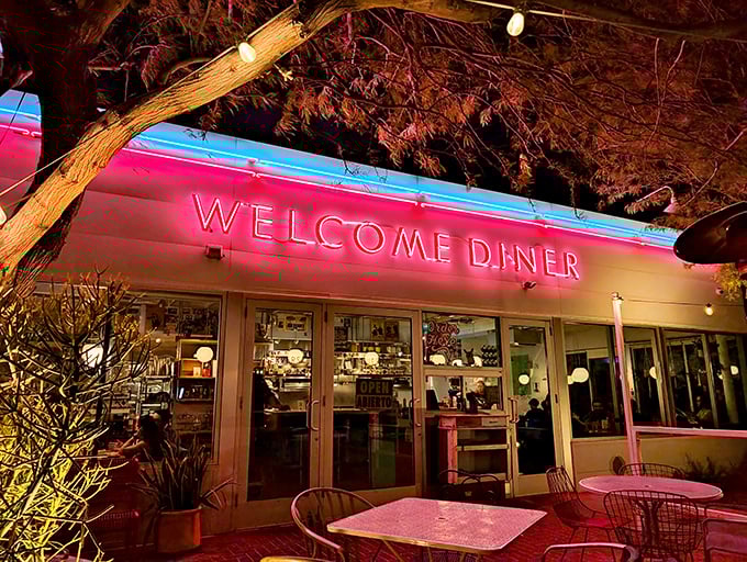 When night falls, Welcome Diner's neon glow transforms into a pink-hued paradise for night owls seeking delicious refuge.