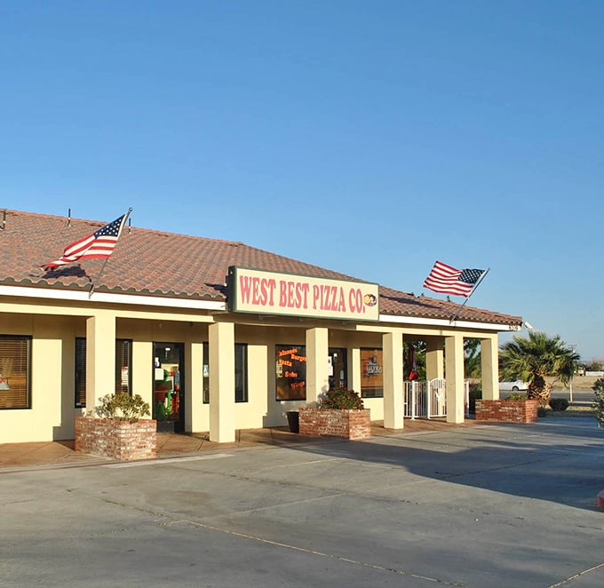 The desert sun highlights West Best Pizza's welcoming entrance, where hungry travelers find pizza salvation in California City.