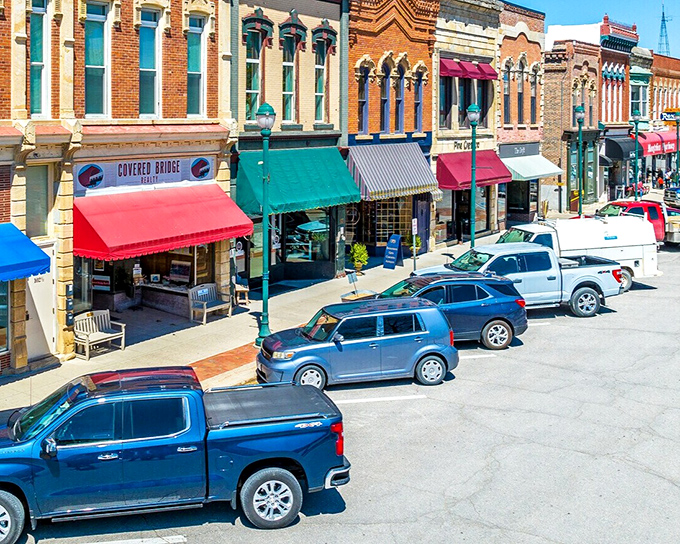 Main Street magic! Winterset's colorful storefronts invite you to stroll, shop, and savor small-town charm that Hollywood couldn't script better.
