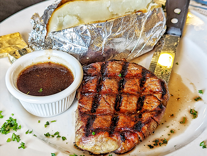 A filet mignon with grill marks so perfect they could be framed in a museum. Paired with a baked potato that's living its best life.