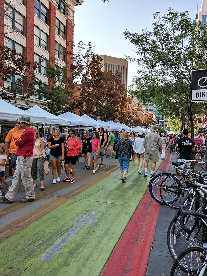The market's colorful human parade flows between white tents, where conversations with strangers feel as natural as breathing.