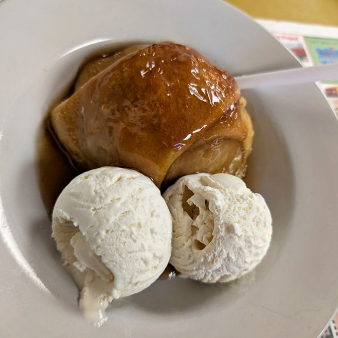 The apple dumpling arrives like a warm hug on a plate, with vanilla ice cream melting into the cinnamon-spiced pastry's nooks and crannies.