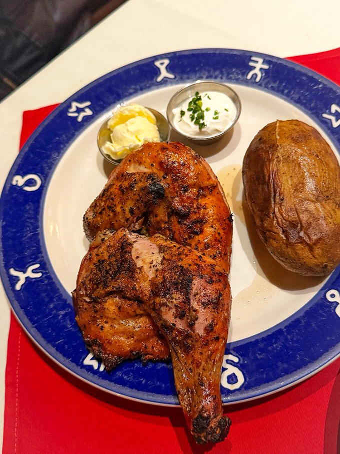 BBQ chicken with the kind of crispy, seasoned skin that makes you forget your table manners. That baked potato is no slouch either.
