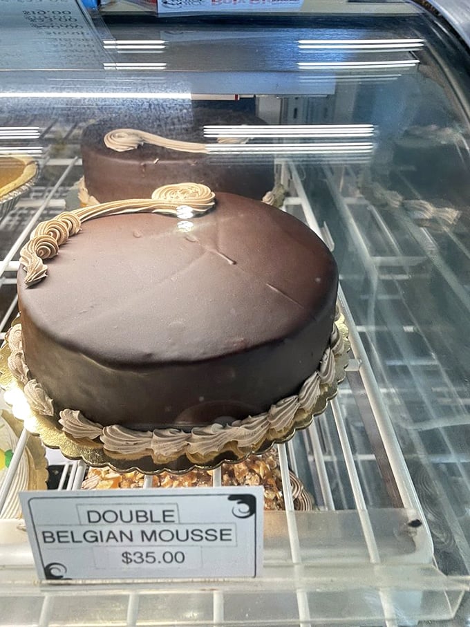 Belgian chocolate mousse cake so decadent it should require a permission slip. The glossy ganache finish is practically hypnotic.