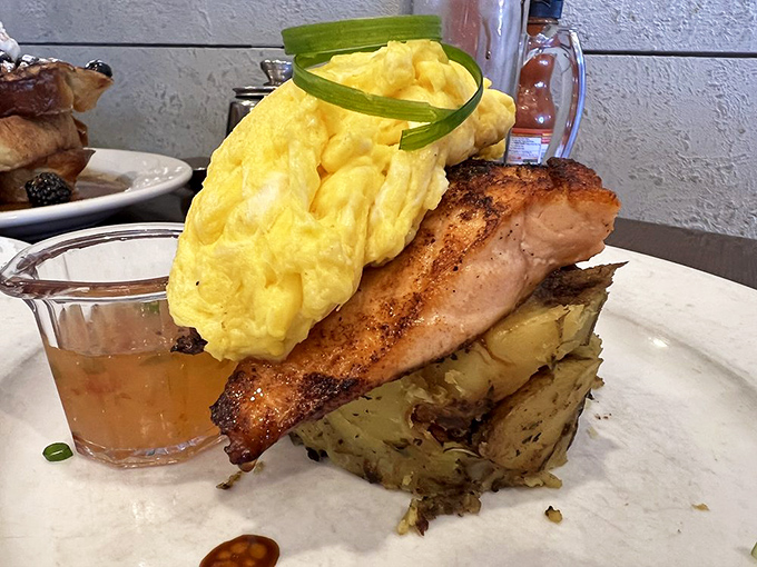 Blackened salmon perched atop a cloud of scrambled eggs and crispy potatoes&mdash;proof that brunch can be both sophisticated and deeply satisfying.