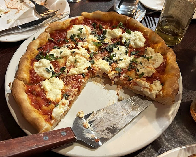 This pizza with its pillowy crust and dollops of fresh cheese proves that sometimes the simplest combinations create the most profound flavors.