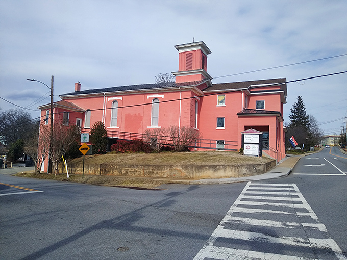 The salmon-colored church building stands as a colorful reminder that not all community landmarks need to be traditionally stately to be significant.