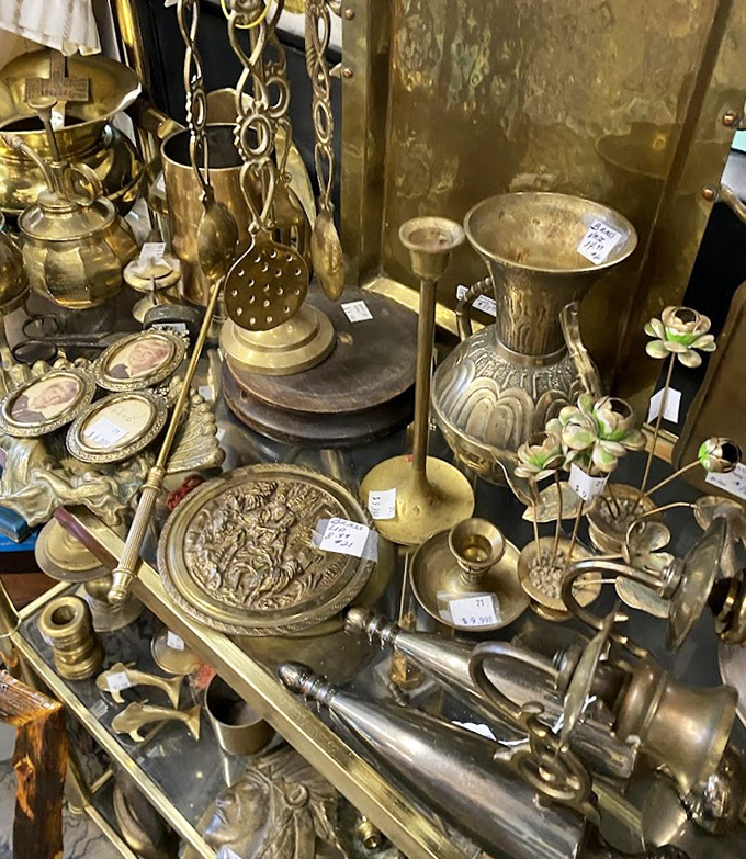 Brass treasures gleam with the patina of history, each candlestick and decorative plate waiting to become your mantel's crowning glory.