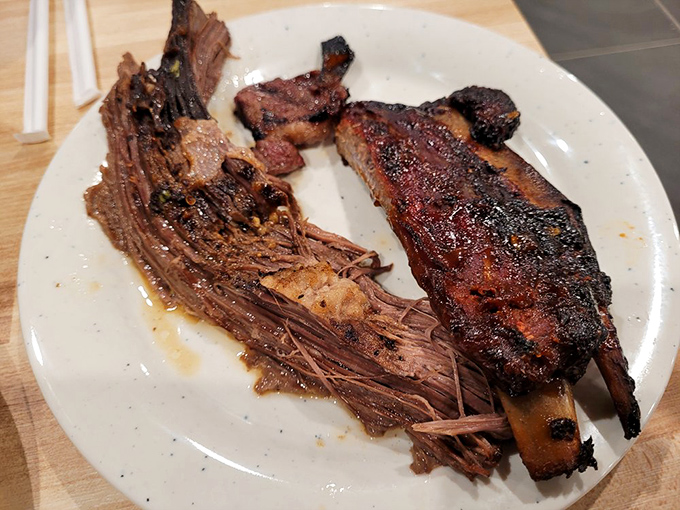 Brisket so tender it's practically surrendering to gravity, alongside ribs that didn't skip their smoke-bath appointment.