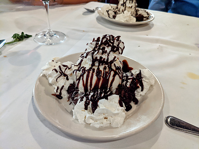 This dessert isn't just served&mdash;it's architected. Whipped cream mountains drizzled with chocolate valleys create a topographic map of deliciousness.