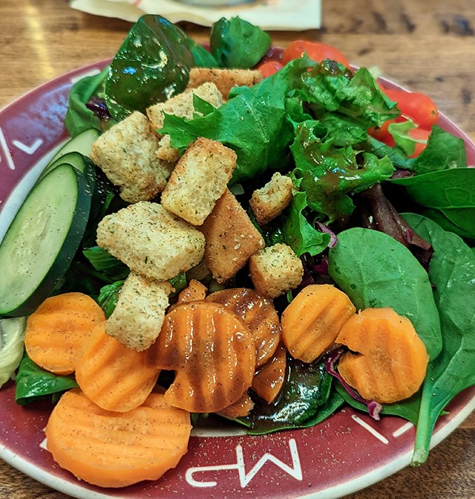 Fresh greens, crispy croutons, and house dressing prove that even the salad course gets star treatment here always.