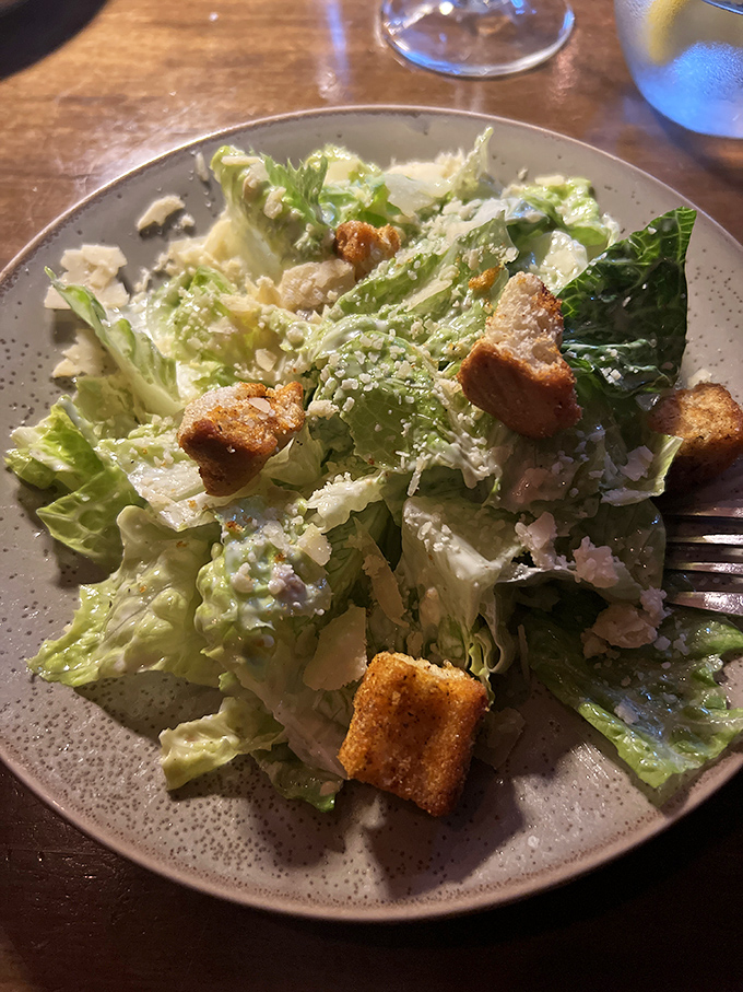 A Caesar salad with proper croutons and generous cheese&mdash;sometimes the classics need no improvement, just proper execution.