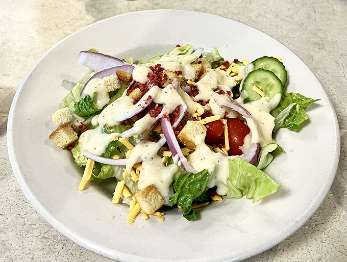 A salad that doesn't apologize for being a salad. Crisp romaine, sharp red onions, and creamy dressing prove that vegetables can party too.