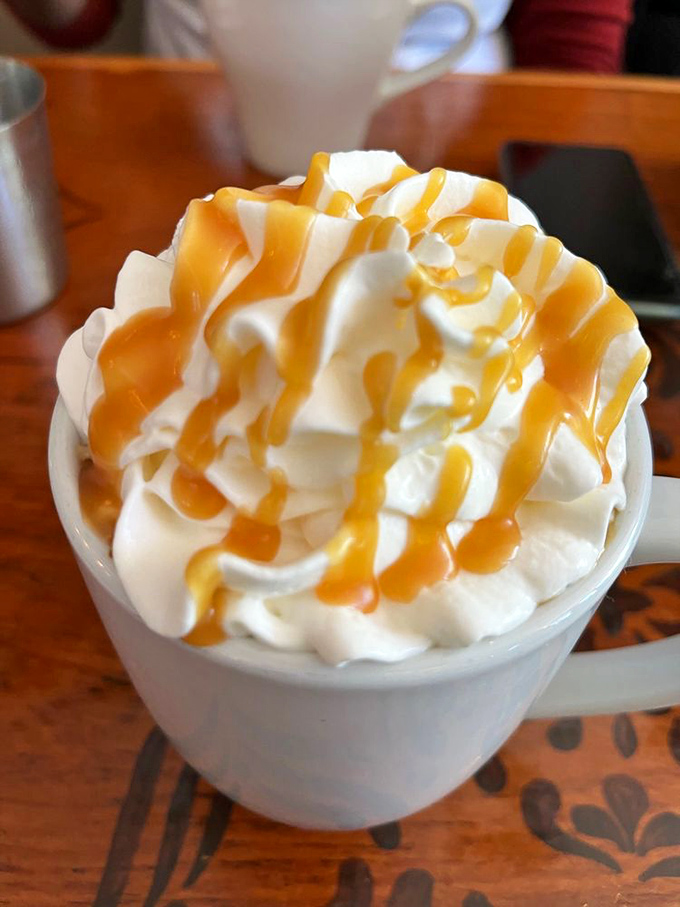 Whipped cream mountains drizzled with caramel rivers &ndash; where coffee becomes dessert and nobody's complaining about it.