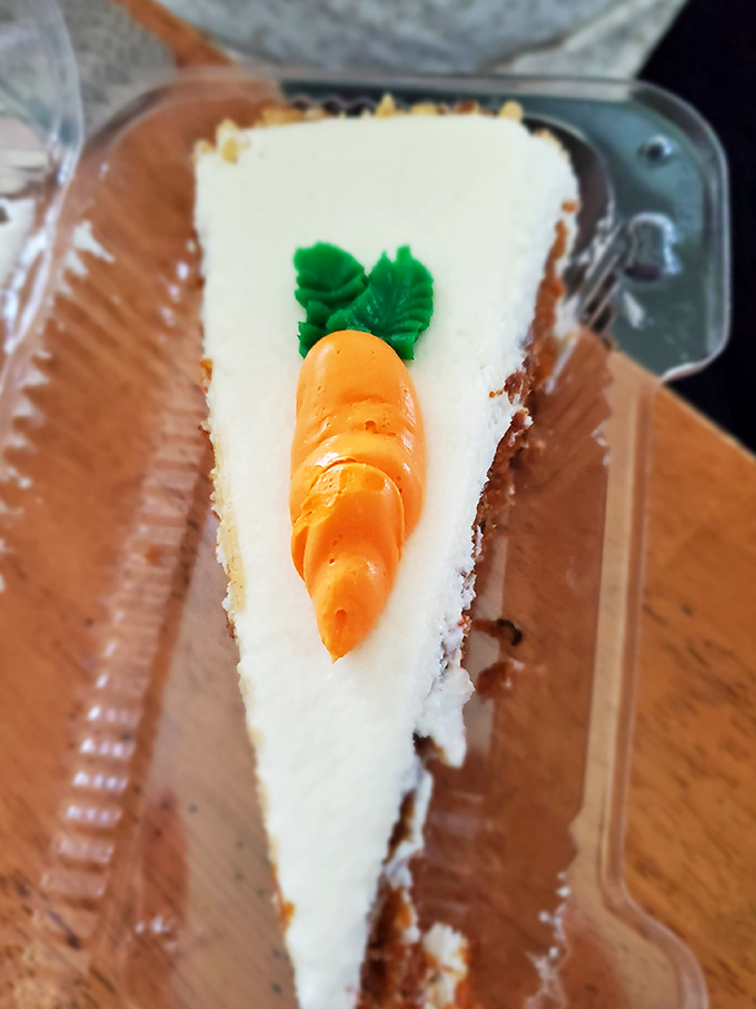 A slice of carrot cake with that adorable decorative carrot on top. The kind of dessert that makes you consider skipping the sandwich entirely.