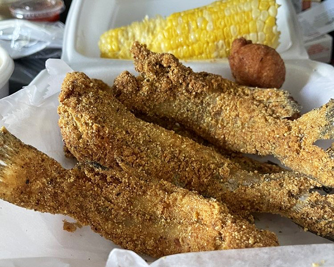Catfish fillets wearing their cornmeal coats with pride, served alongside sweet corn&mdash;proof that simple food done right needs no fancy introduction.