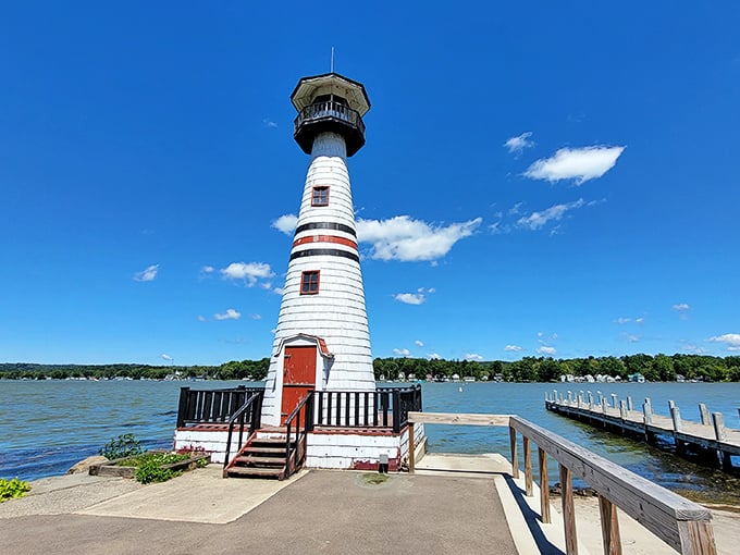 Celoron's charming lighthouse keeps watch over Chautauqua Lake, a candy-striped sentinel against picture-perfect blue skies.