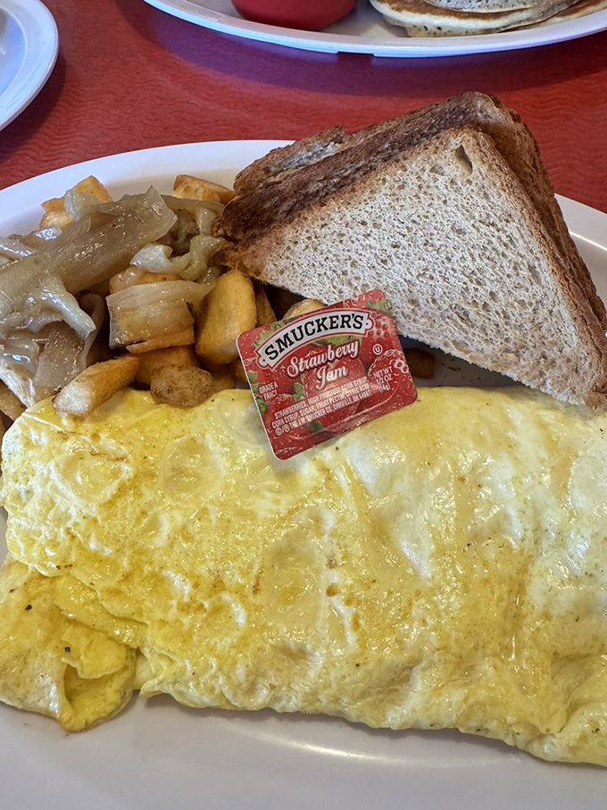 That omelet looks so fluffy it might float away if not anchored by toast and those perfectly crispy potatoes.
