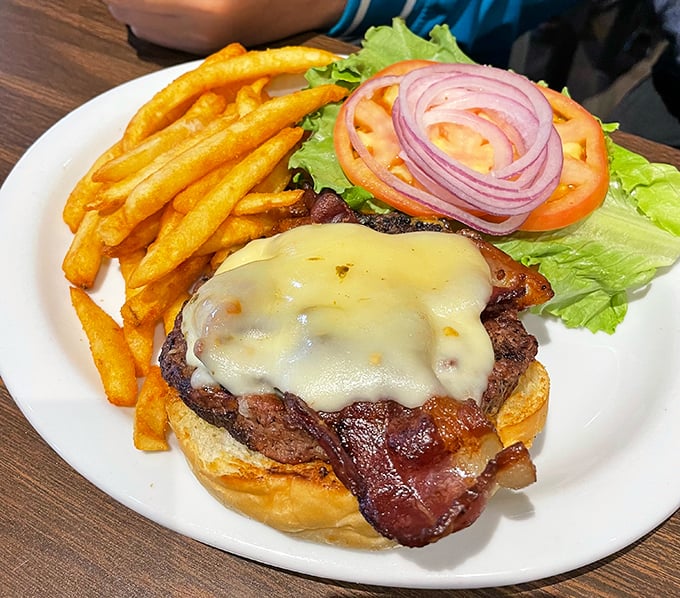A burger that understands the importance of proper cheese melt, bacon placement, and the structural integrity needed to support such ambition.