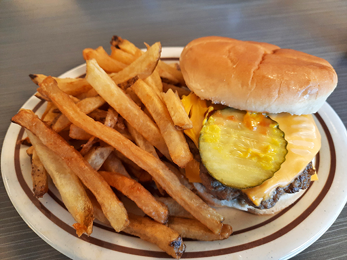This cheeseburger and fries combo is the platonic ideal of American lunch. That pickle slice isn't garnish&mdash;it's essential architecture.