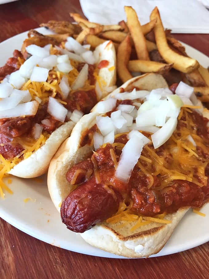 Hot dogs elevated to an art form&mdash;smothered in chili, cheese, and onions. Proof that sometimes the most satisfying foods require both hands and extra napkins.