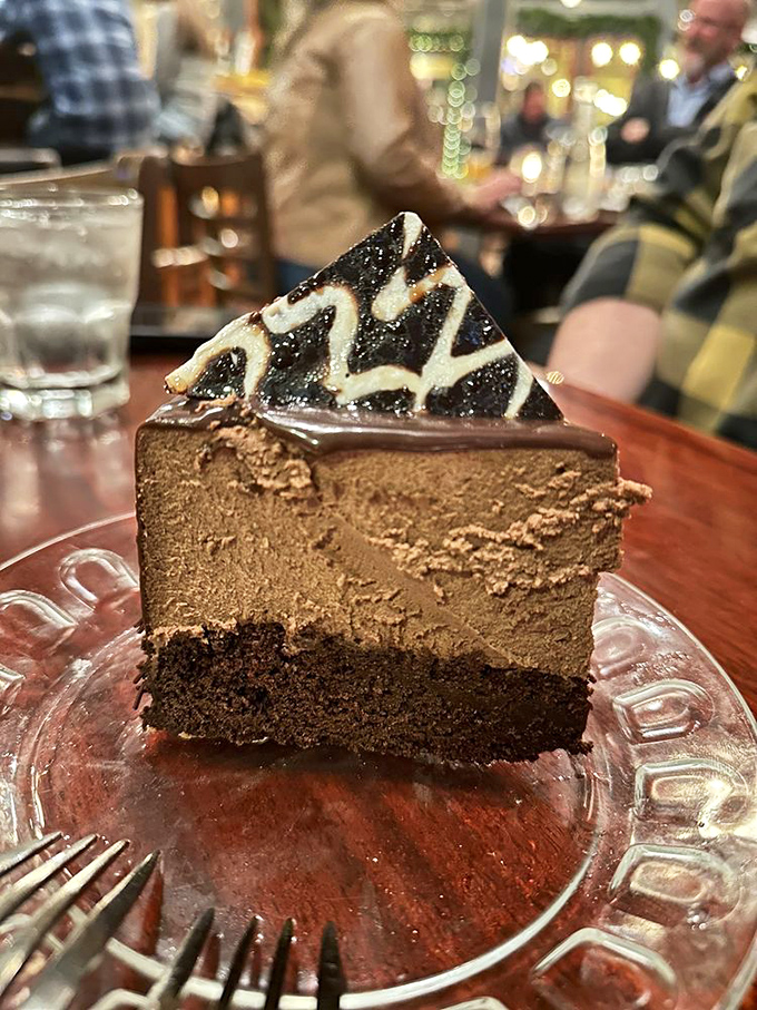 A chocolate cake so rich it probably has its own offshore bank account. That decorative drizzle is just showing off at this point.