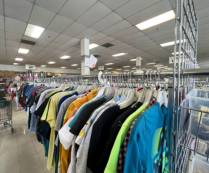 Color-coded clothing racks make hunting for specific items less daunting. The rainbow organization system turns what could be chaos into a surprisingly methodical treasure hunt.