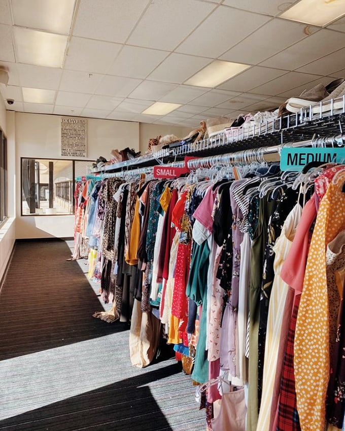 A rainbow of possibilities hangs neatly organized by size, proving that secondhand shopping isn't just economical&mdash;it's a treasure hunt with style dividends.