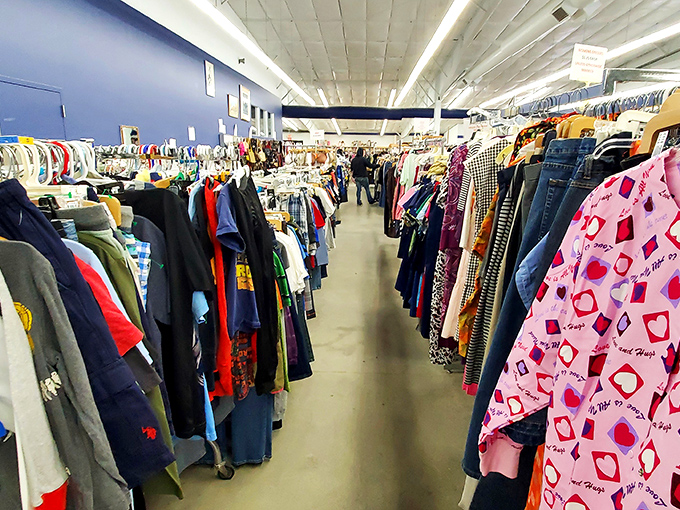 The clothing section stretches toward the horizon, a textile rainbow where vintage treasures hide among everyday basics.