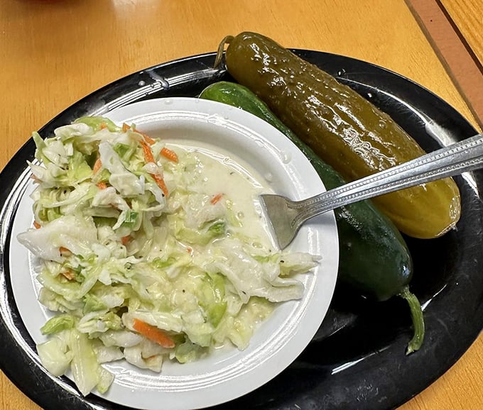 The supporting cast deserves applause too: tangy coleslaw and pickles with enough snap to wake up your taste buds. 