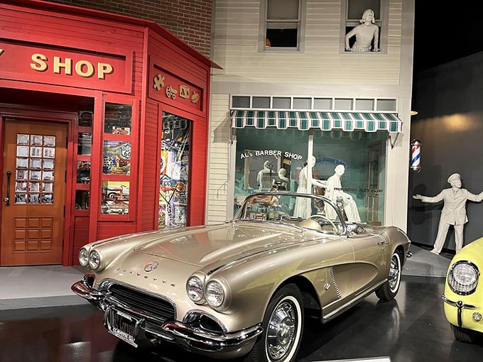 Parked outside a recreated mid-century storefront, this champagne-colored Corvette looks ready for its owner to emerge from the barber shop, keys in hand.